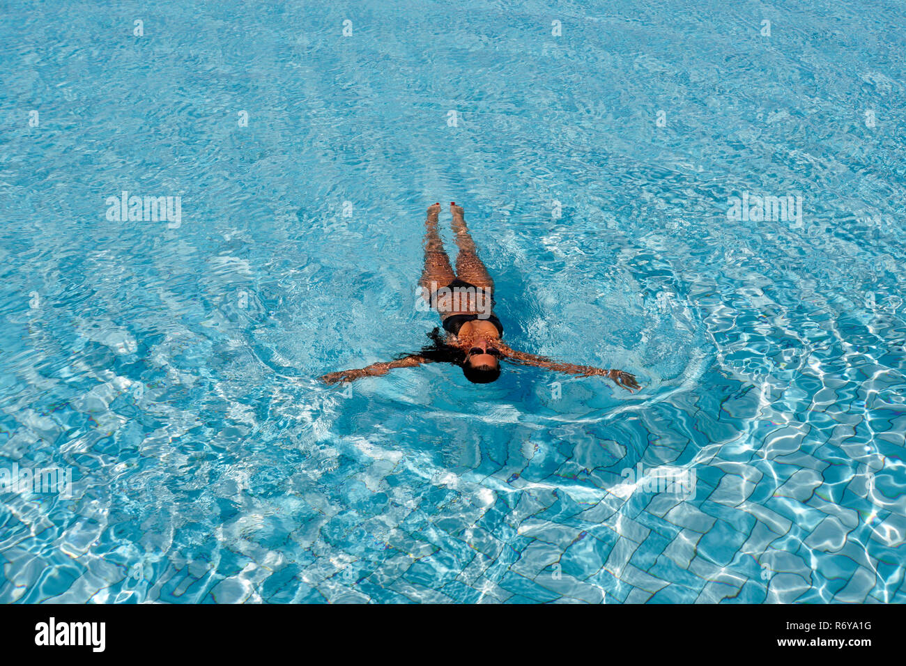 Serene woman floats in pool hi-res stock photography and images - Alamy
