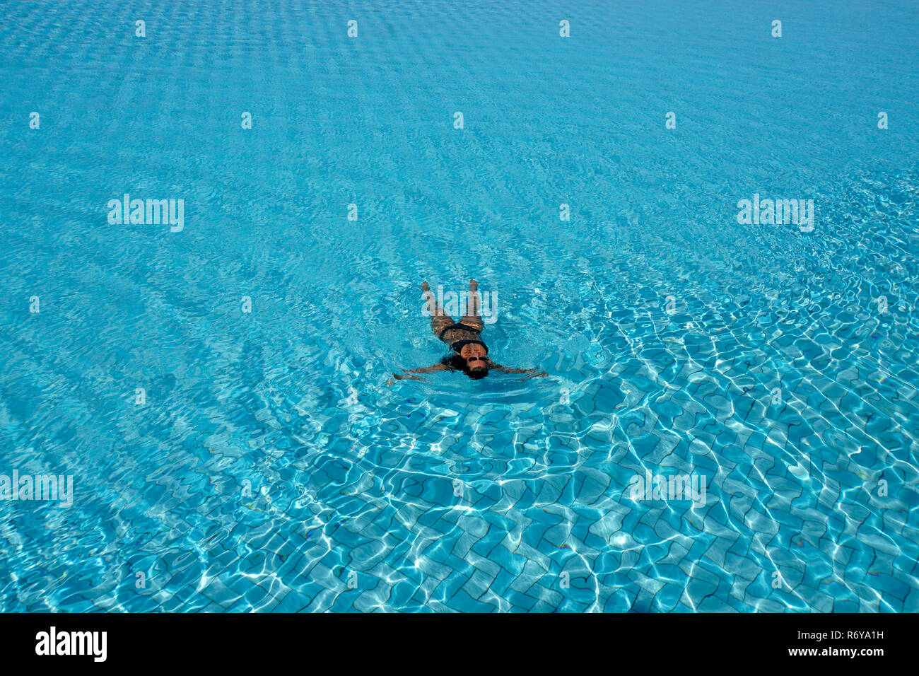 Serene woman floats in pool hi-res stock photography and images - Alamy