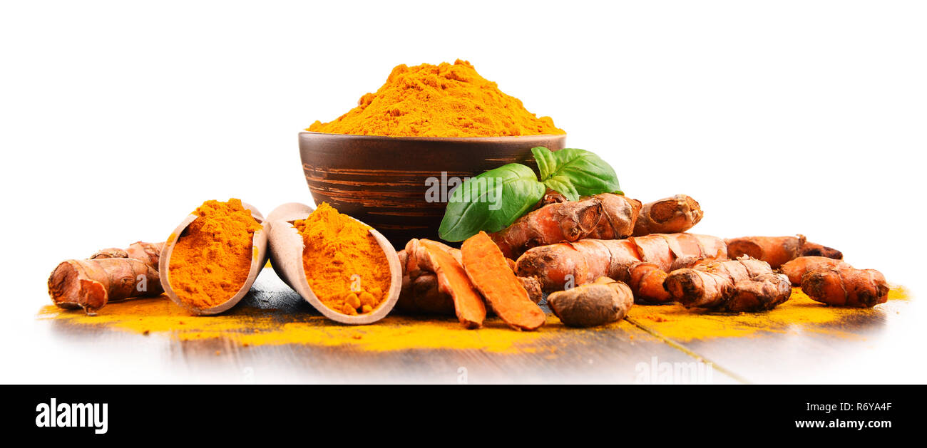 Bowl of turmeric powder over white background Stock Photo - Alamy