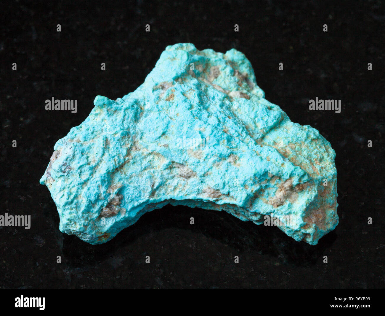 rough Turquoise stone on black Stock Photo - Alamy