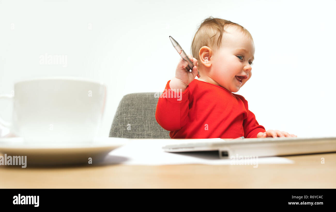 Happy child baby girl toddler sitting with keyboard of computer ...