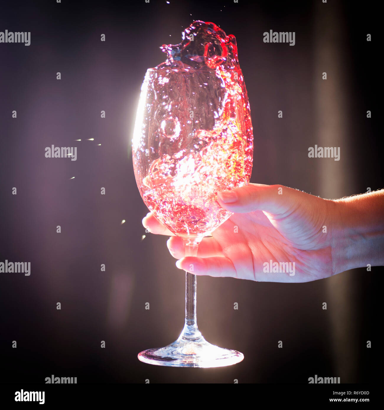 splashing wine in glass Stock Photo - Alamy