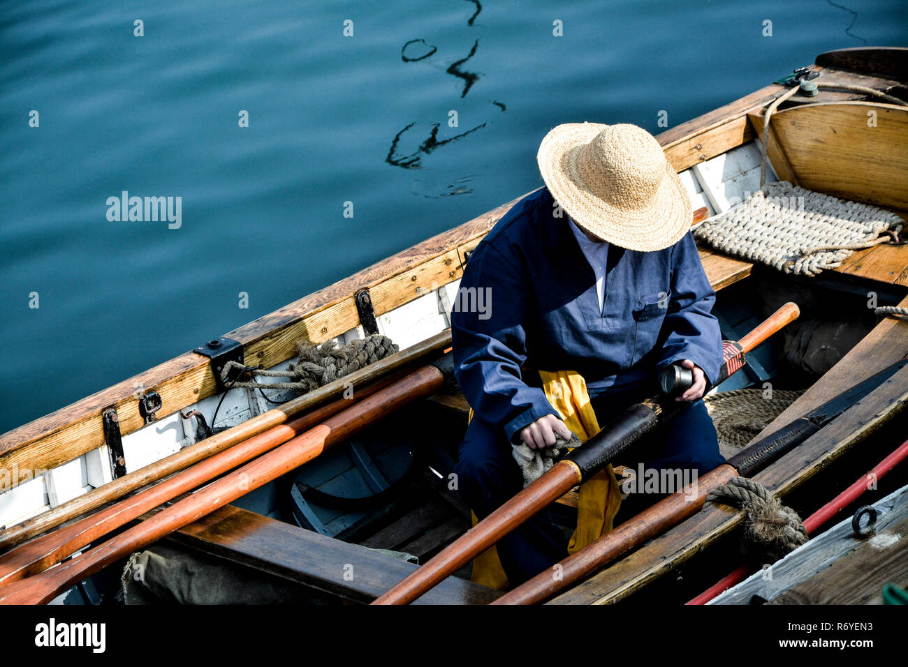 Fisherman working on his boat Stock Photo - Alamy