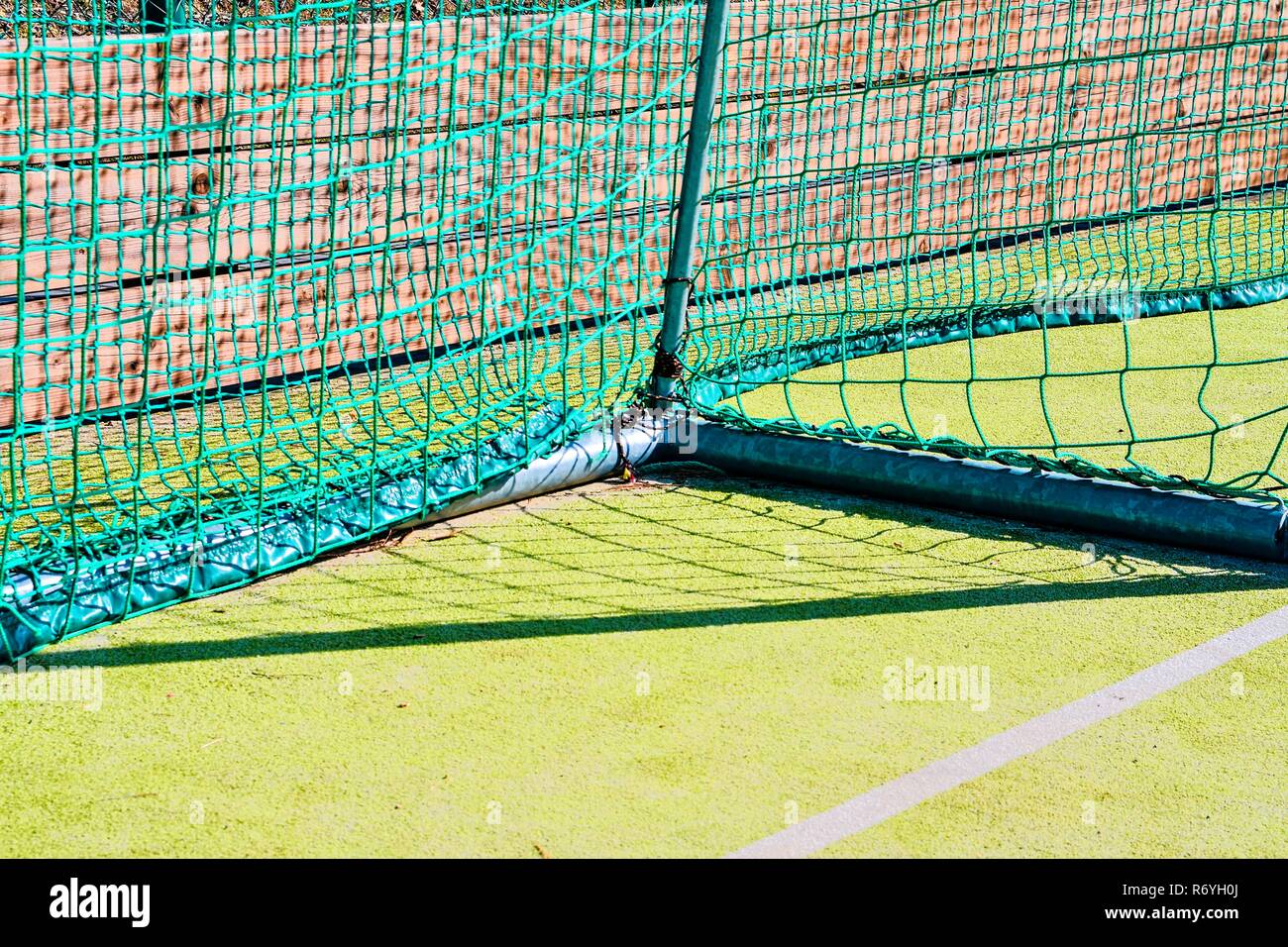 Goal with net and green playing field. Closeup. Sport texture and ...
