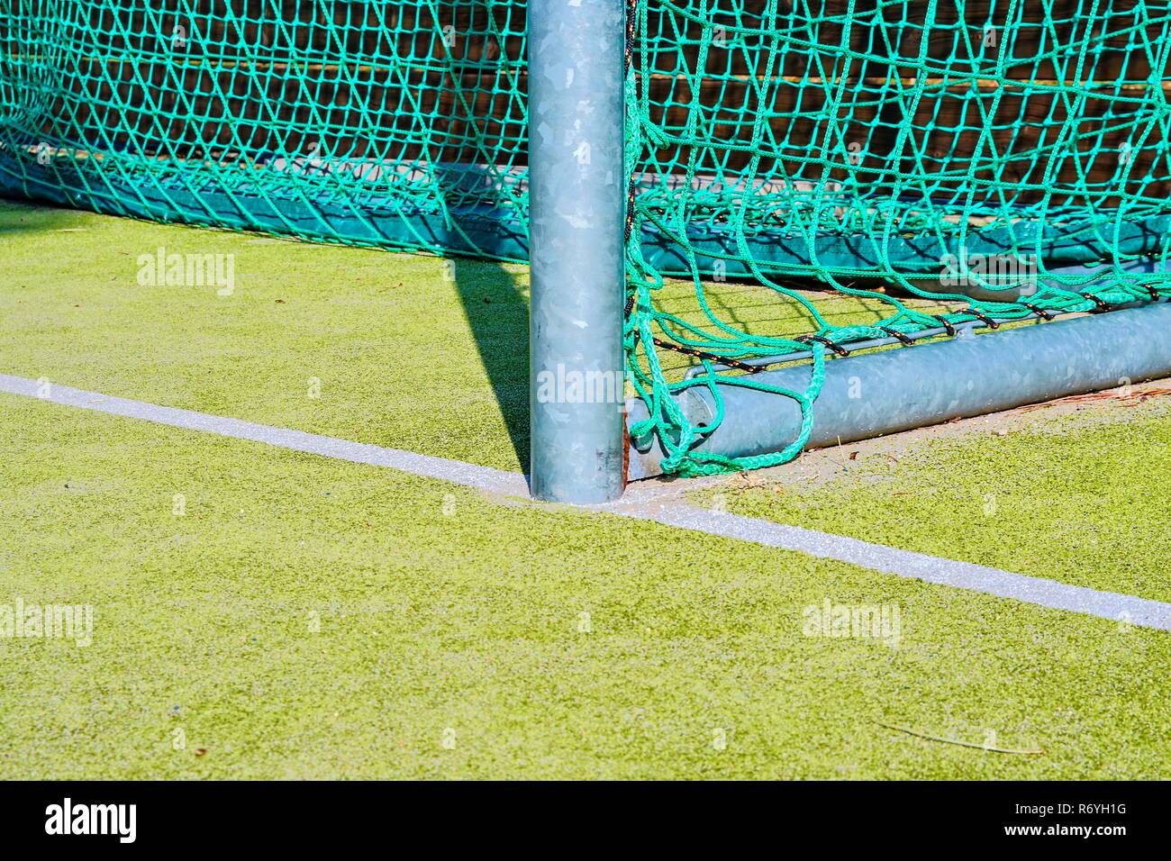 Goal with net and green playing field. Closeup. Sport texture and ...