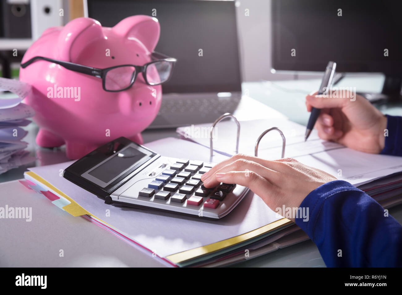 Businessperson Calculating Bill With Calculator Stock Photo - Alamy