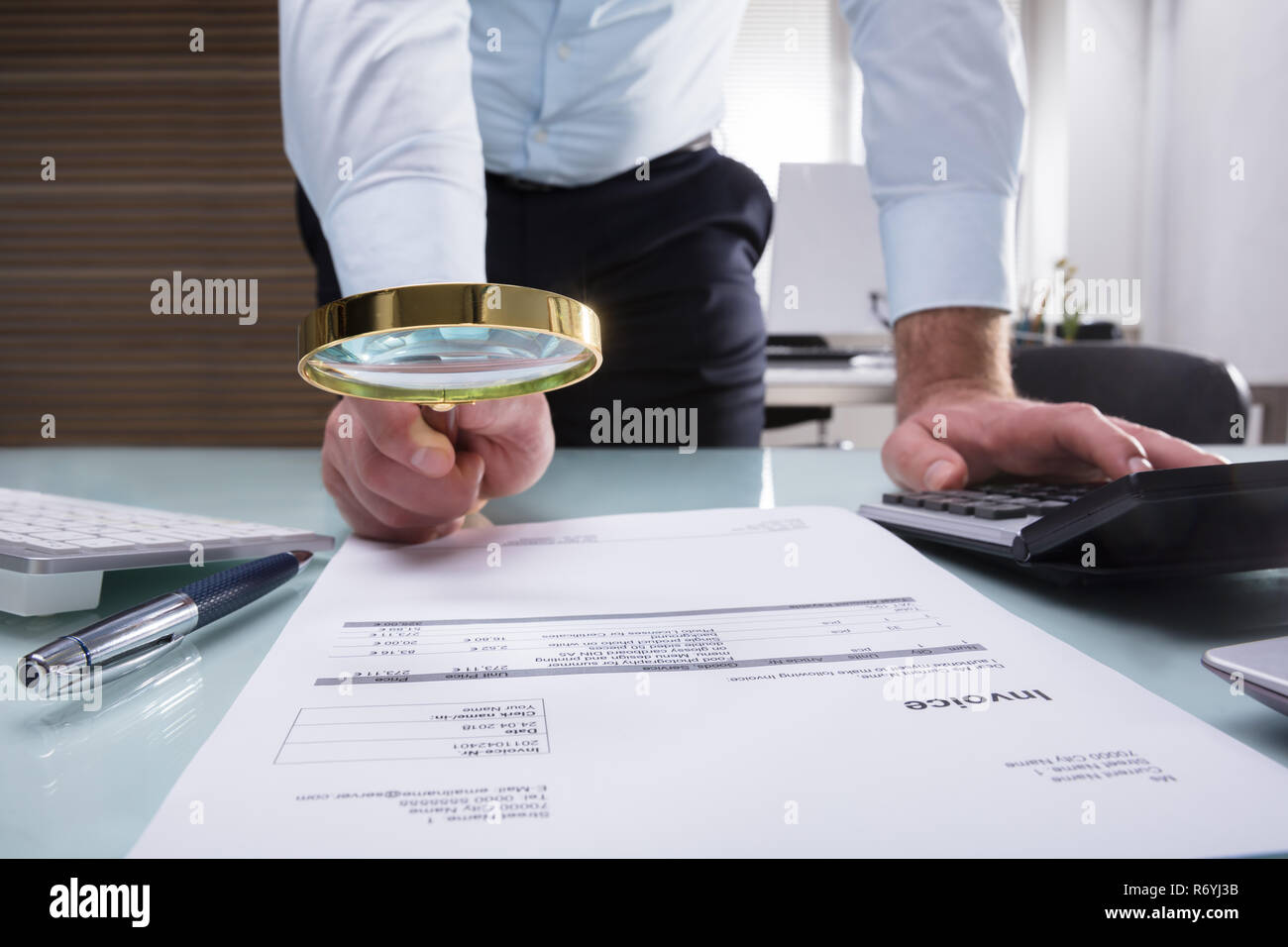 Human Hand Holding Magnifying Glass Over Invoice Stock Photo - Alamy