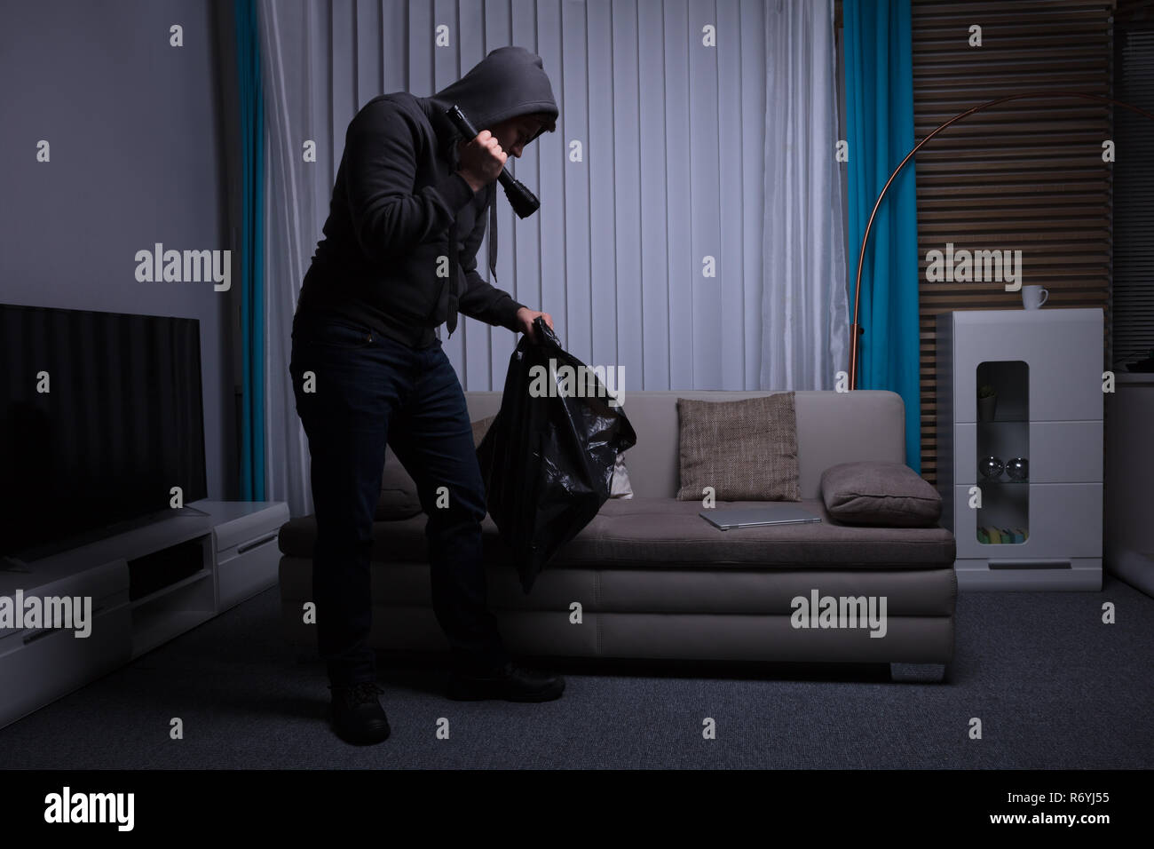 Robber Standing In Living Room Stock Photo - Alamy