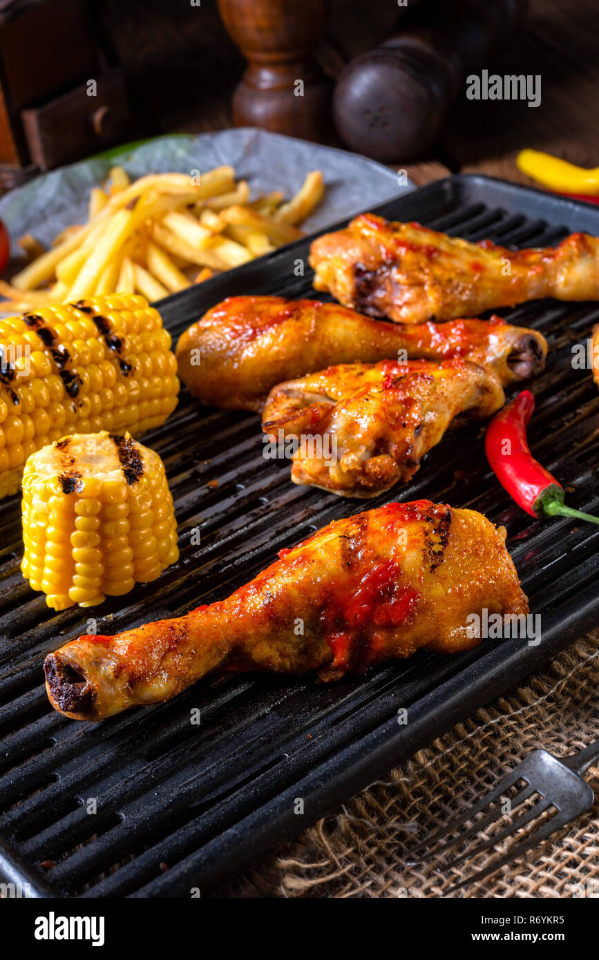 rustic grilled chicken wings,legs,and spicy corn Stock Photo - Alamy