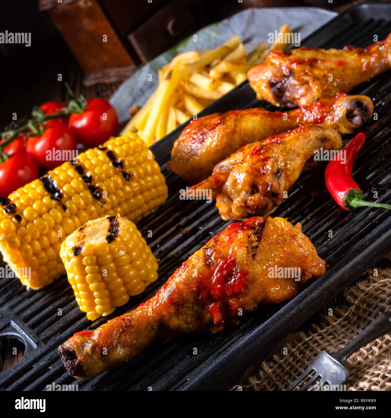 rustic grilled chicken wings,legs,and spicy corn Stock Photo - Alamy