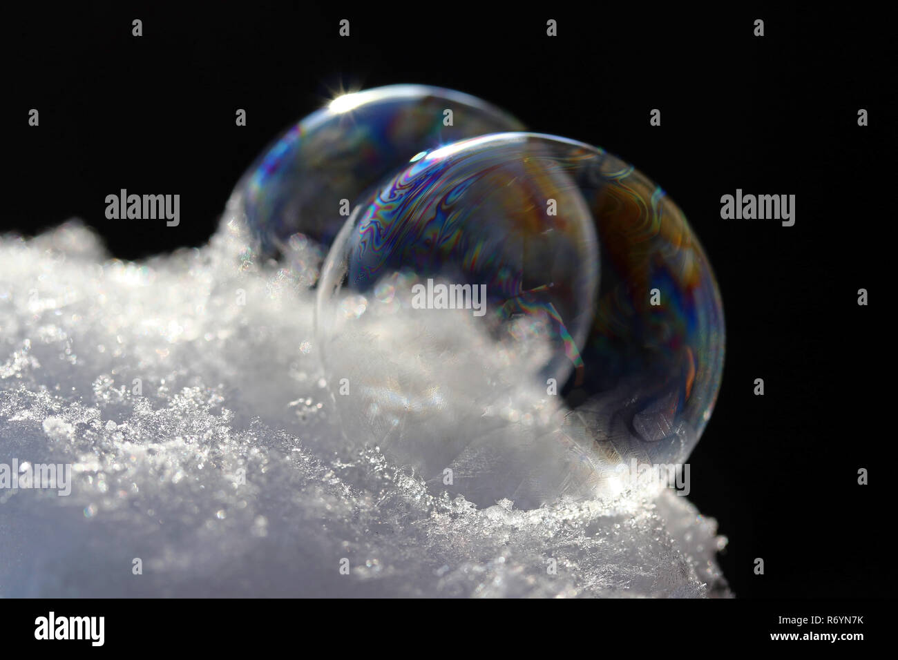 two colorful soap bubbles on snow Stock Photo - Alamy