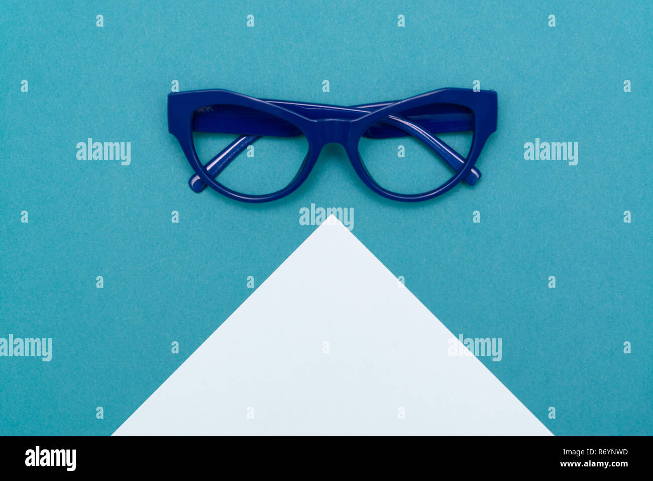 Top view flat lay, modern blue eye glasses on pastel paper background ...