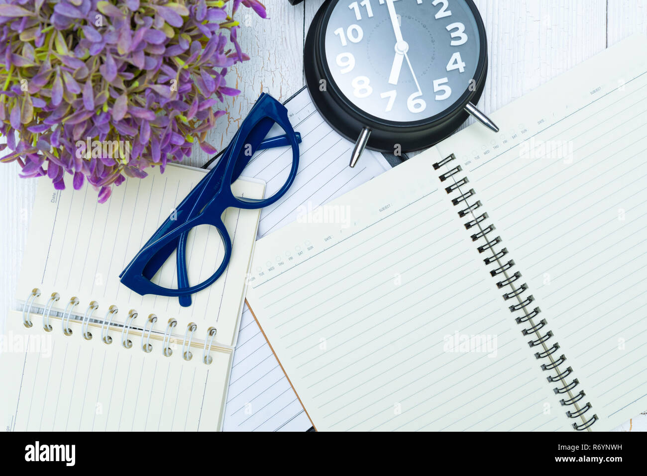 Blank notebook paper page and glasses with pen and office supplies, top ...
