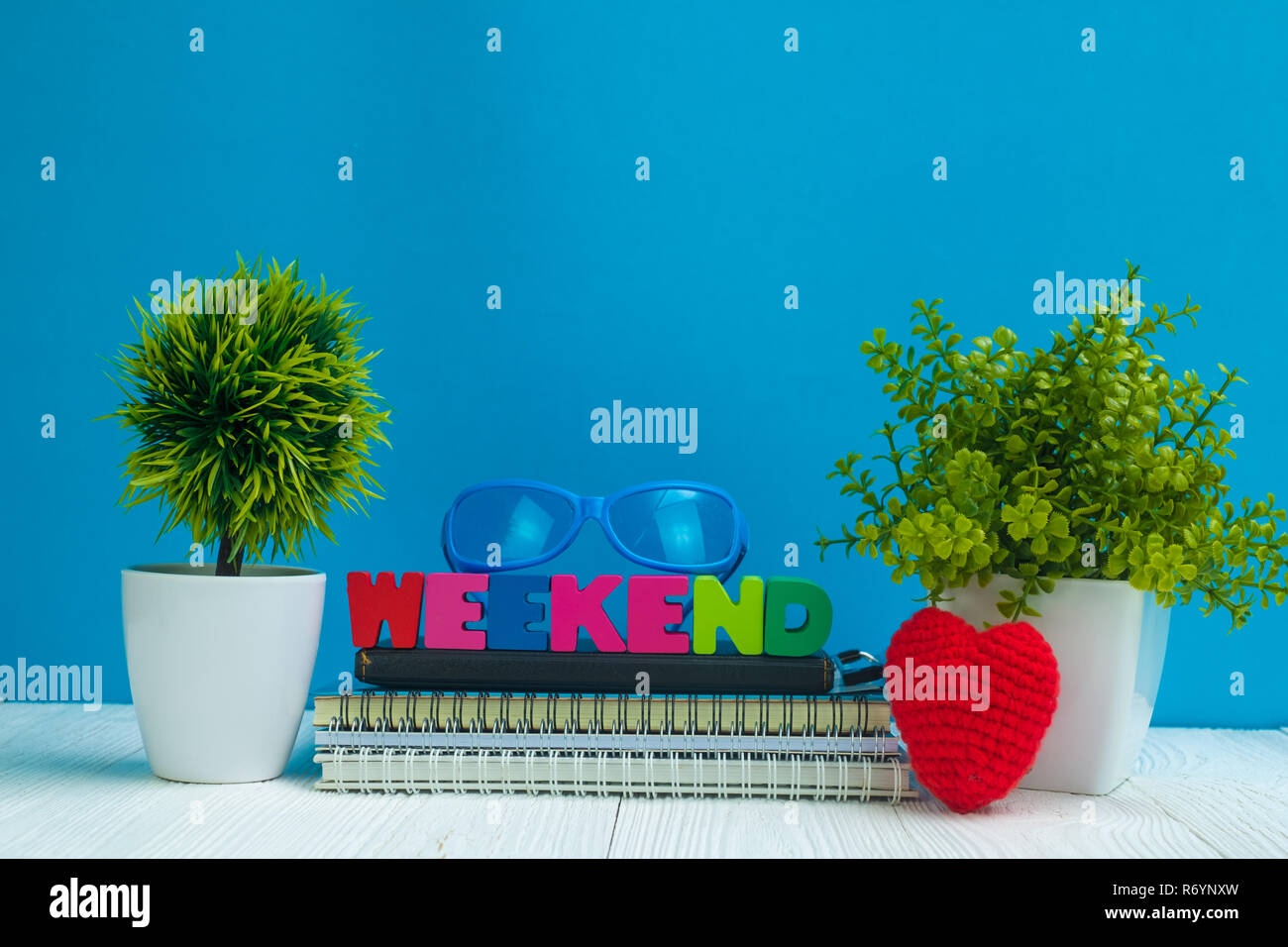 WEEKEND letters text and notebook paper and little decoration tree in ...