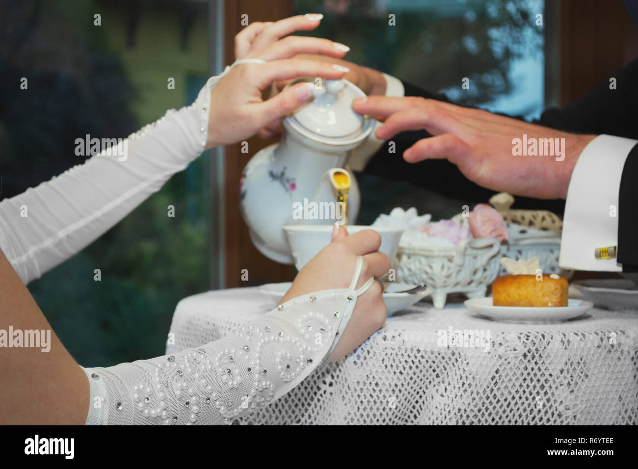 The bride and groom drink tea at the cafe Stock Photo - Alamy