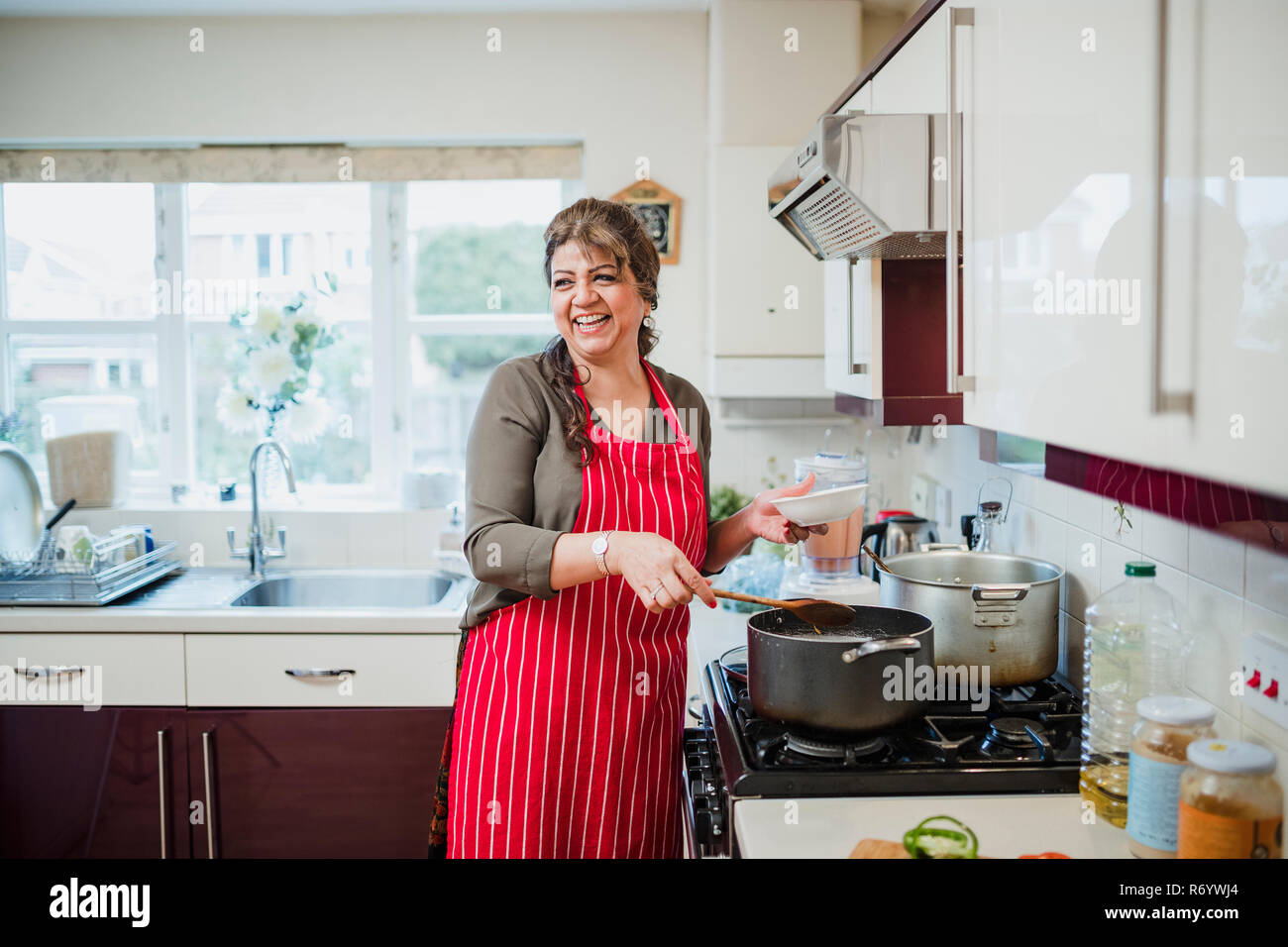 Mature Woman Enjoying Cooking at Home Stock Photo - Alamy