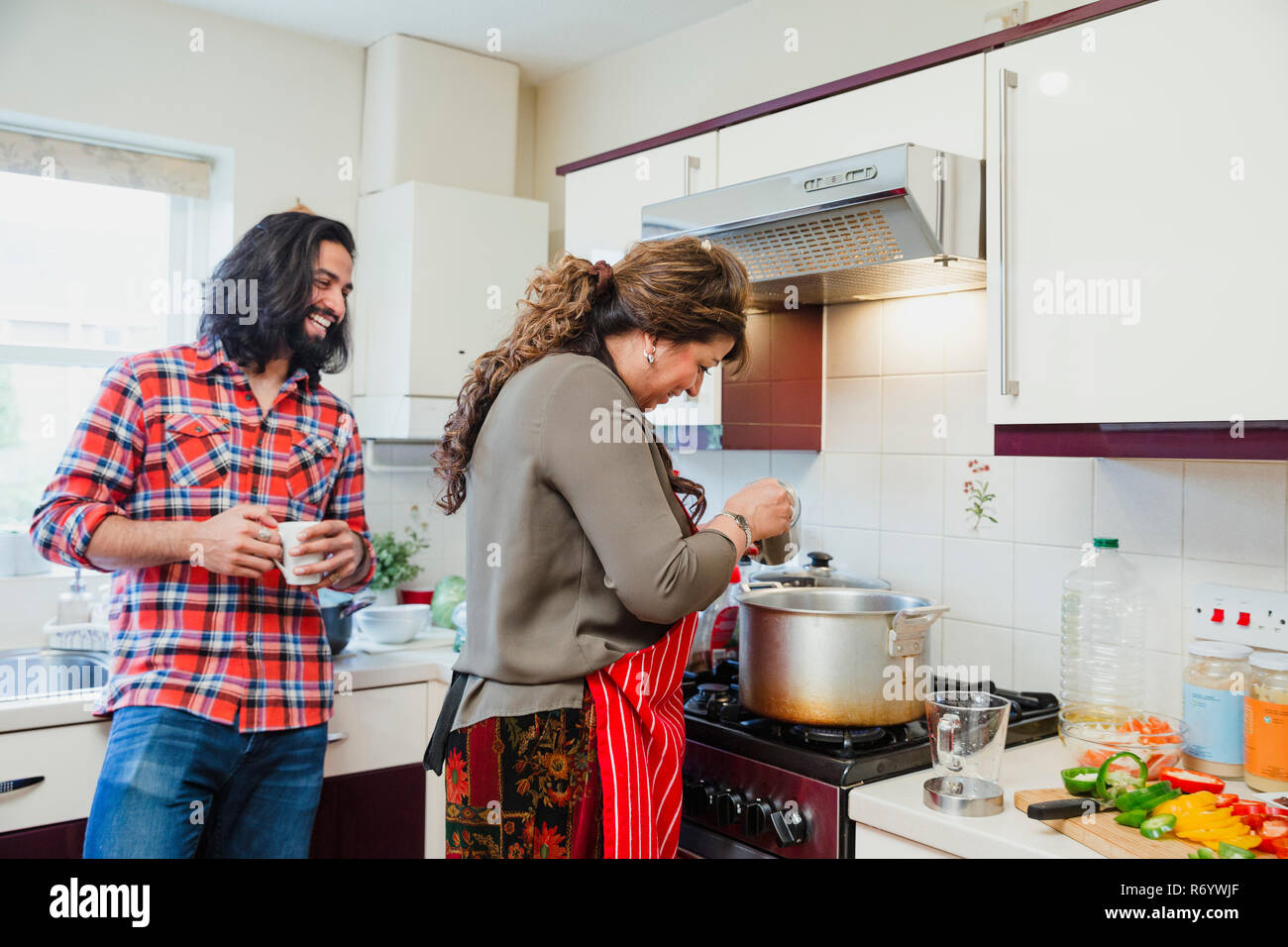 Keeping Mum Company While she Cooks Stock Photo - Alamy
