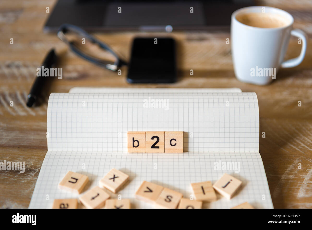 Closeup on notebook over wood table background, focus on wooden blocks ...