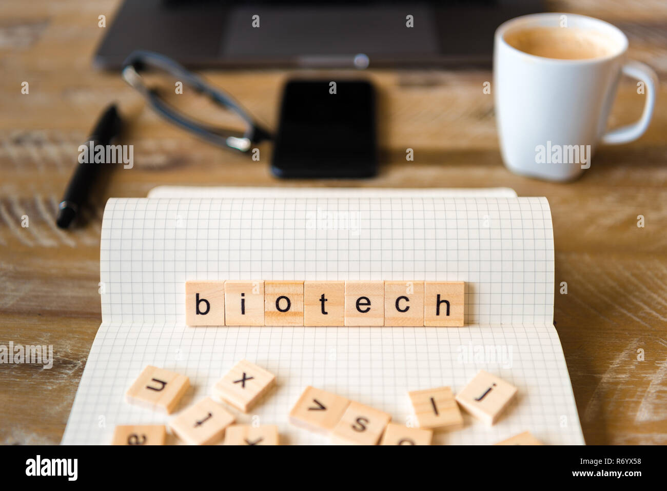 Closeup on notebook over wood table background, focus on wooden blocks ...