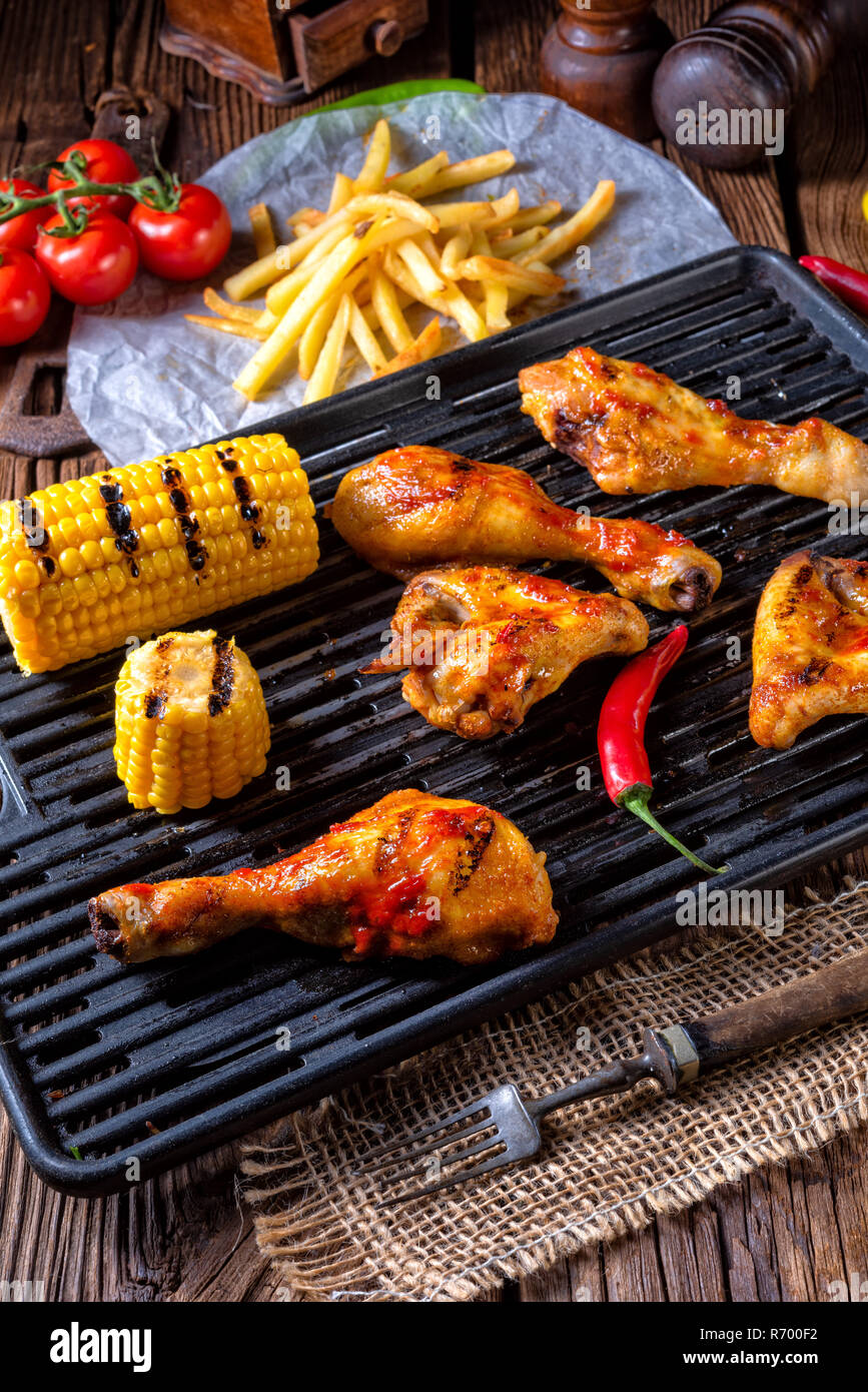 rustic grilled chicken wings,legs,and spicy corn Stock Photo - Alamy