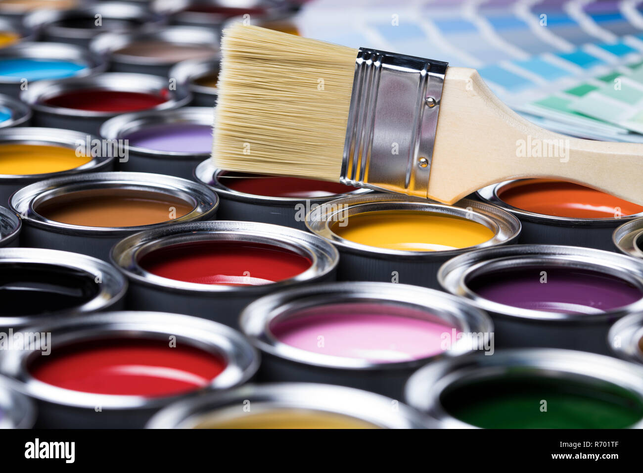 Colorful paint cans with paintbrush Stock Photo - Alamy
