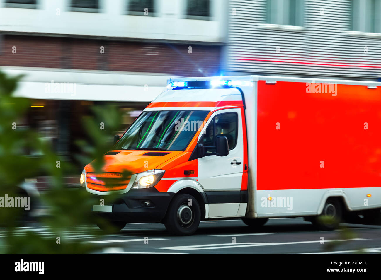 ambulance car speeding in the city Stock Photo - Alamy
