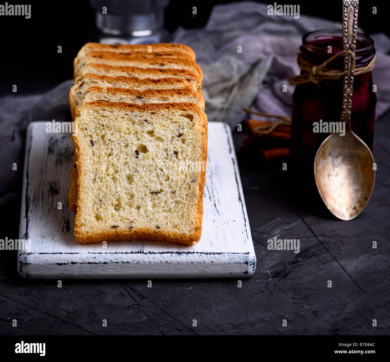 Square pieces of bread from white wheat flour with flax seeds Stock ...