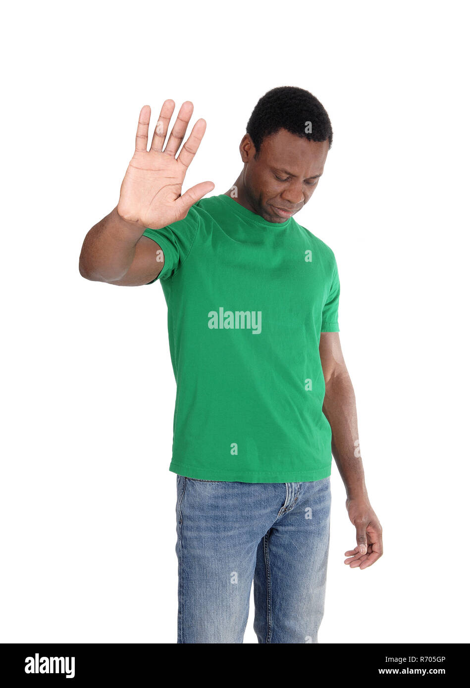 Handsome young man holding up his hand Stock Photo - Alamy