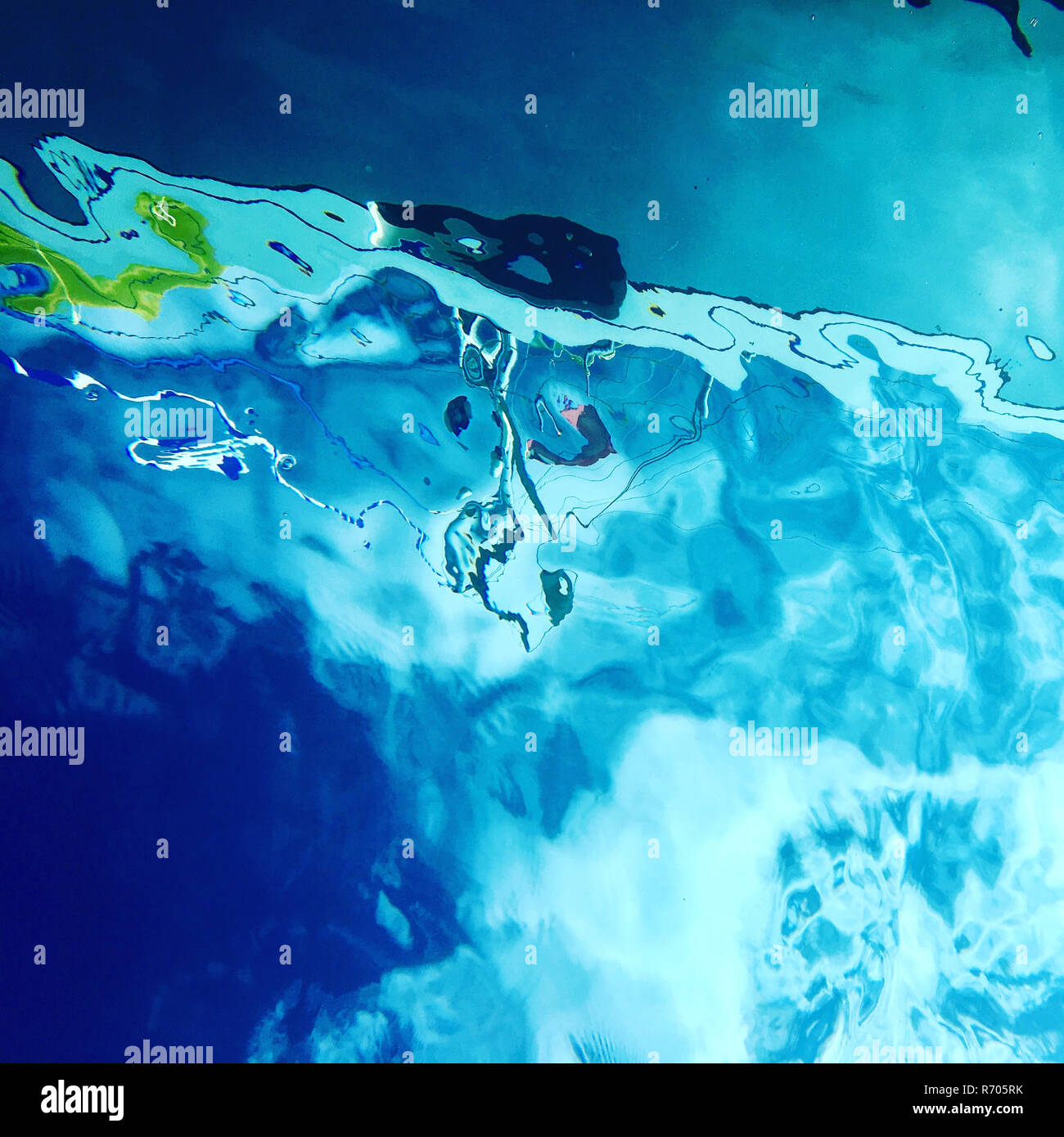 reflection of a sailboat in a gently moving water Stock Photo - Alamy