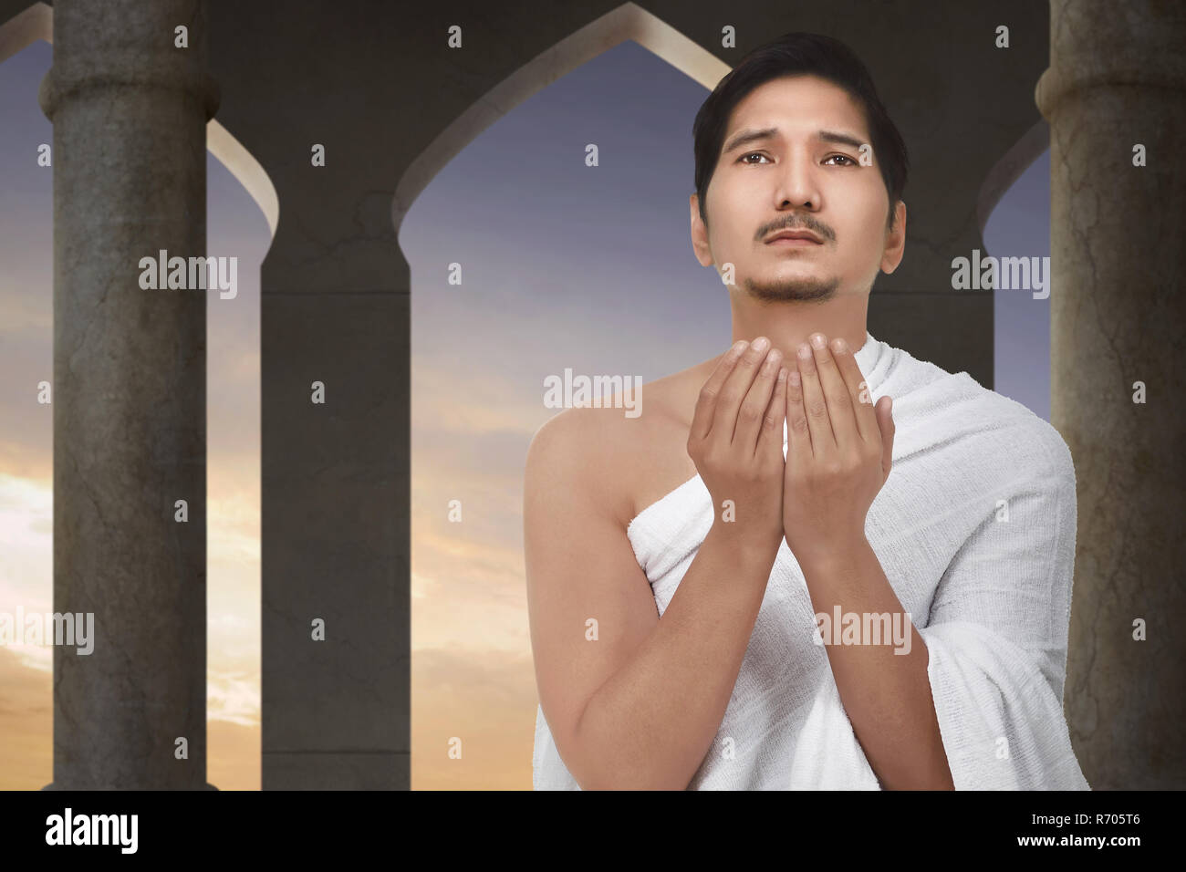 Attractive asian muslim man praying to god Stock Photo - Alamy