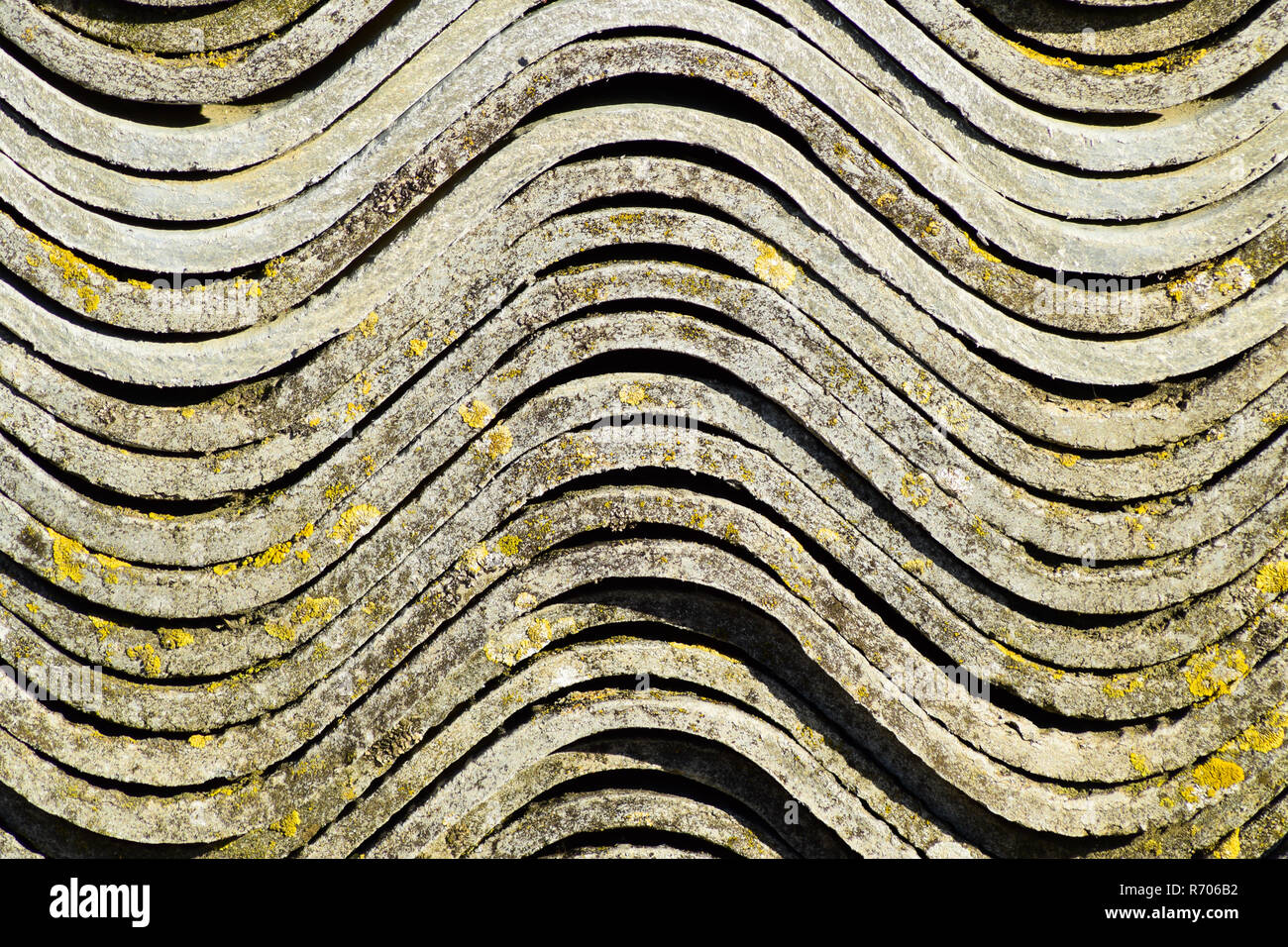Corrugated slate lies in a pile, side view background texture of slate ...