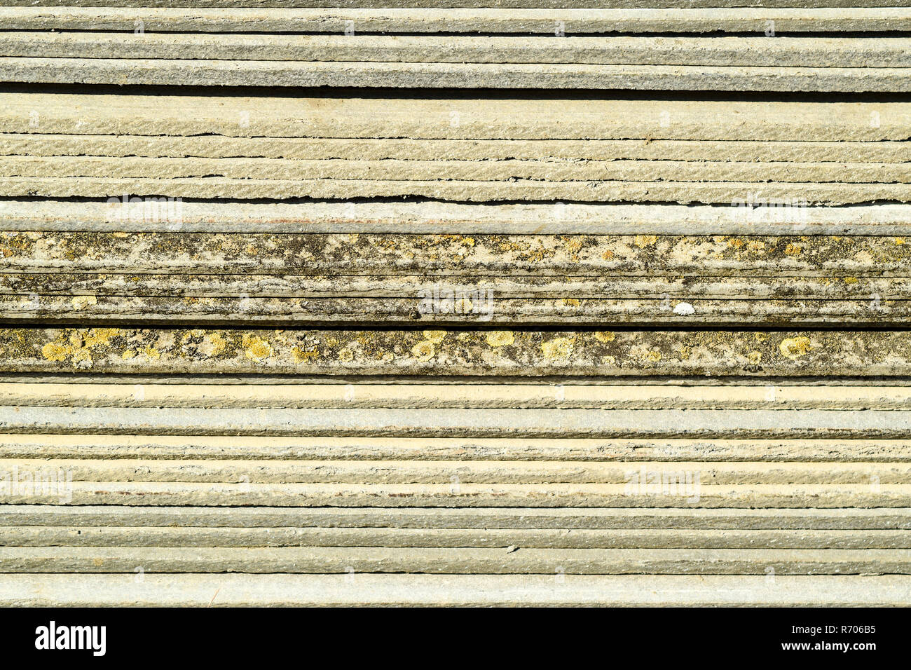 Corrugated slate lies in a pile, side view background texture of slate ...