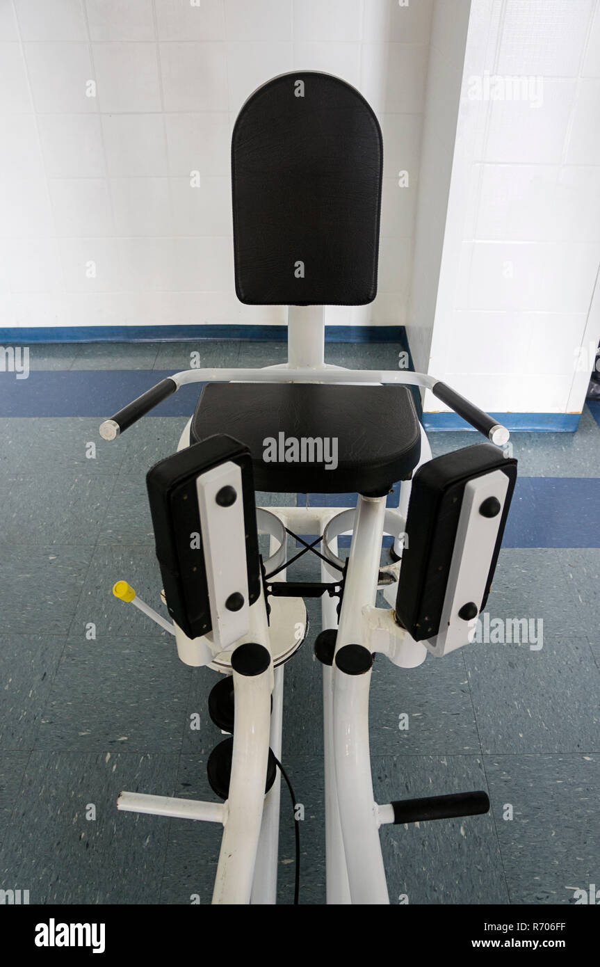 abduction aduction machine indoors gym equipment Stock Photo - Alamy
