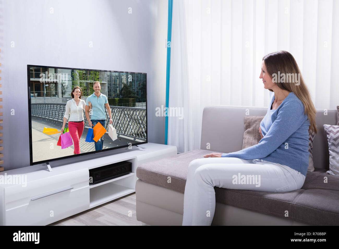 Old lady watching tv on sofa hi-res stock photography and images - Alamy