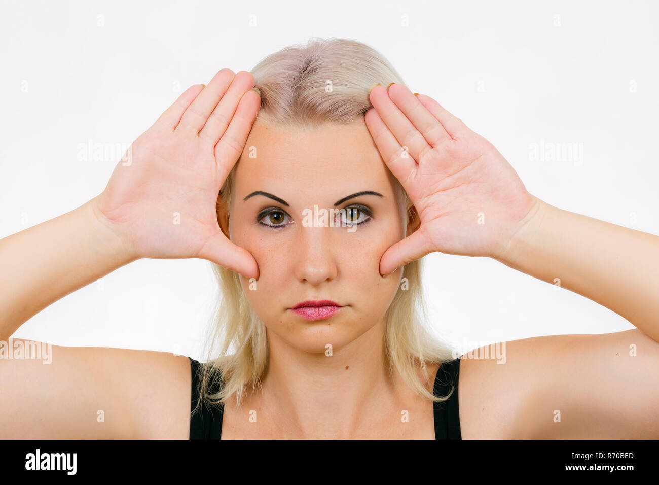 Face exercise cheekbone push up, female face with hands pulling the ...