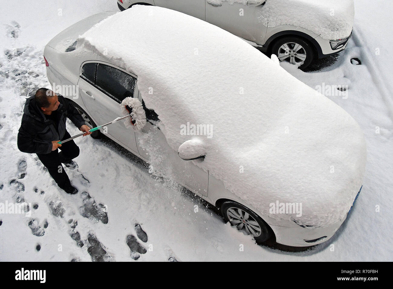 Yantai, China's Shandong Province. 7th Dec, 2018. A man clears snow ...