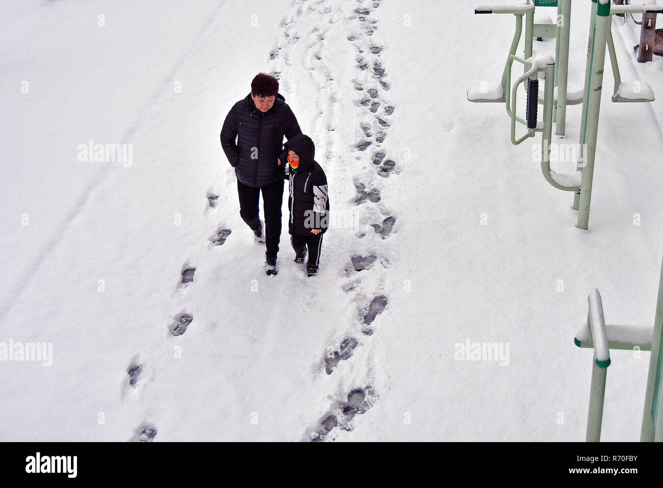 Yantai, China's Shandong Province. 7th Dec, 2018. Pedestrians walk on a ...