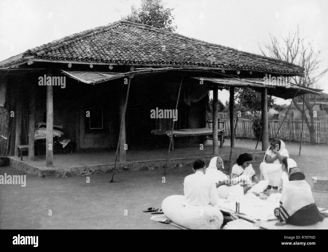 Mahatma Gandhi with supporters outside his hut at Sevagram Ashram ...