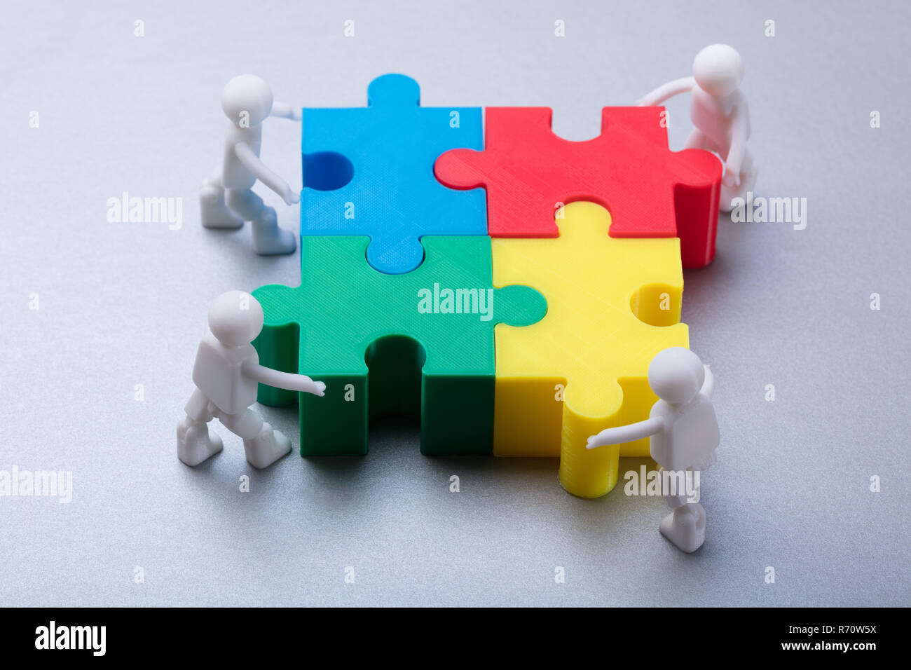 Human Figures Solving Jigsaw Puzzle Stock Photo - Alamy