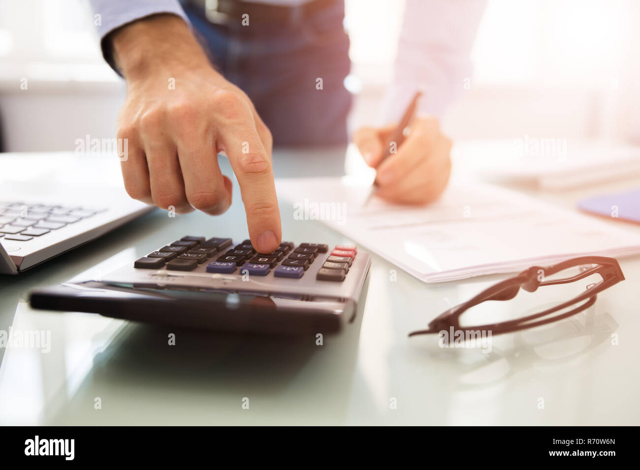 Businessperson Using Calculator Stock Photo - Alamy