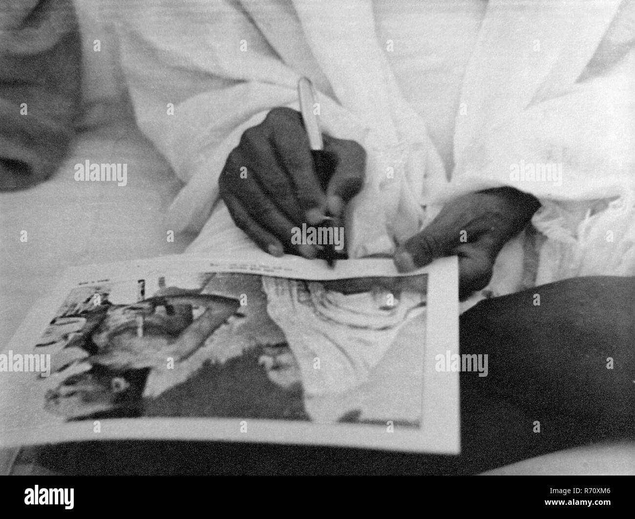 Mahatma Gandhi giving an autograph on his photograph, India, old ...
