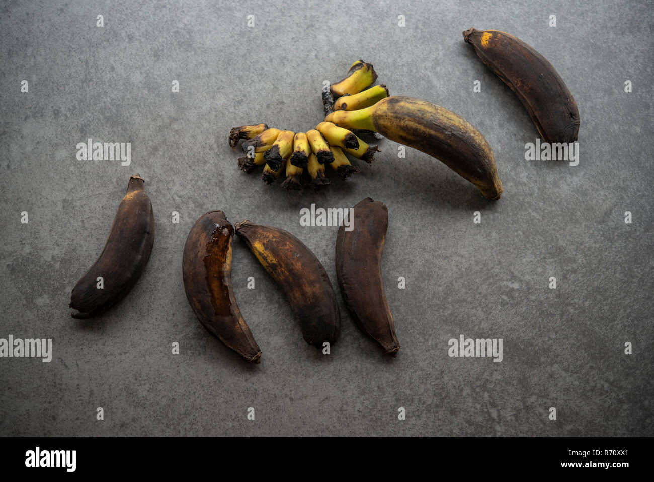 Rotten bananas on grey background Stock Photo - Alamy