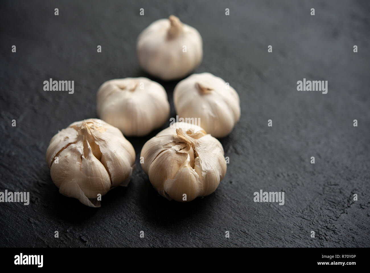Garlic with copy space on dark background Stock Photo - Alamy