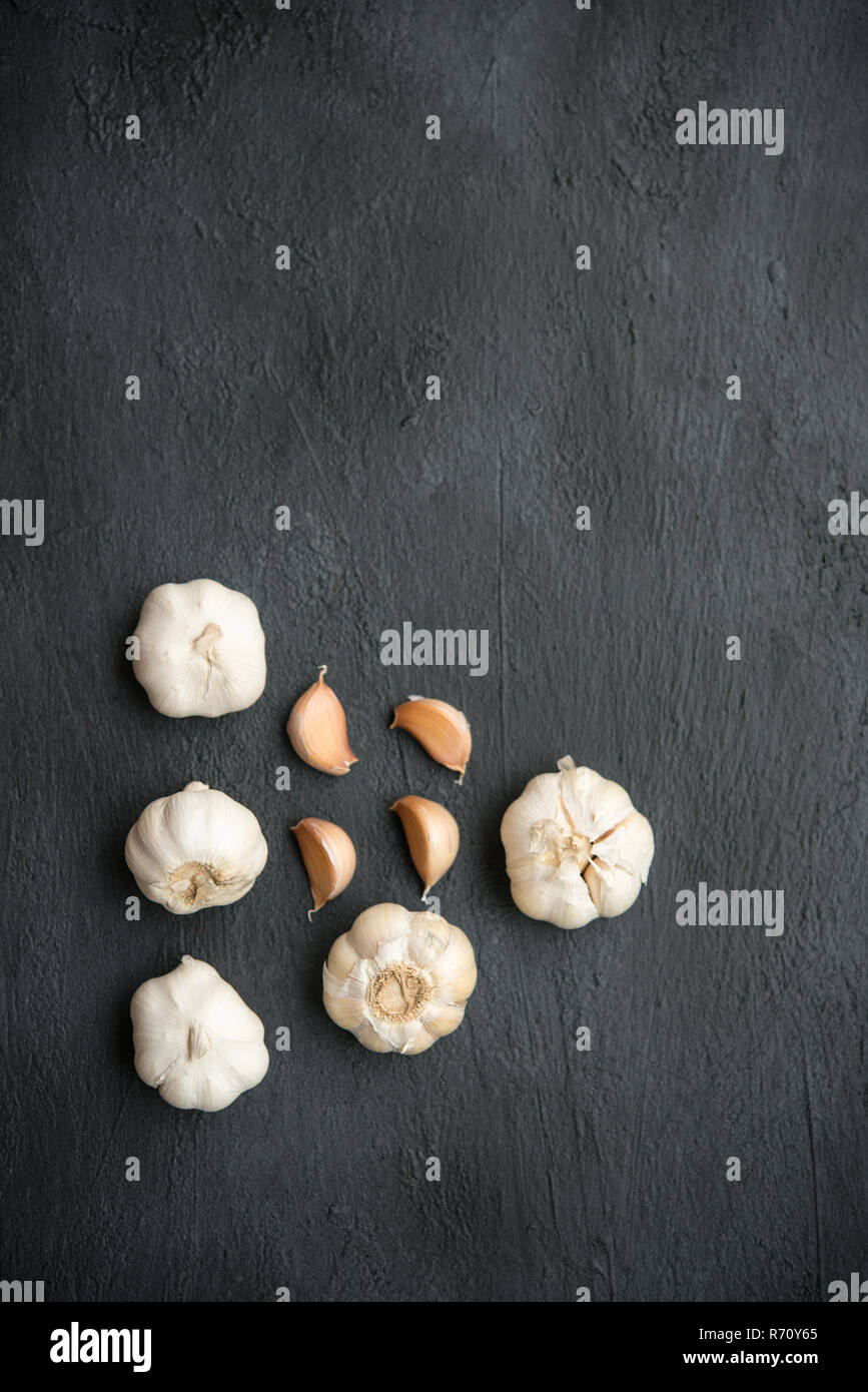 Top view garlic cloves and bulb with copy space on dark background ...
