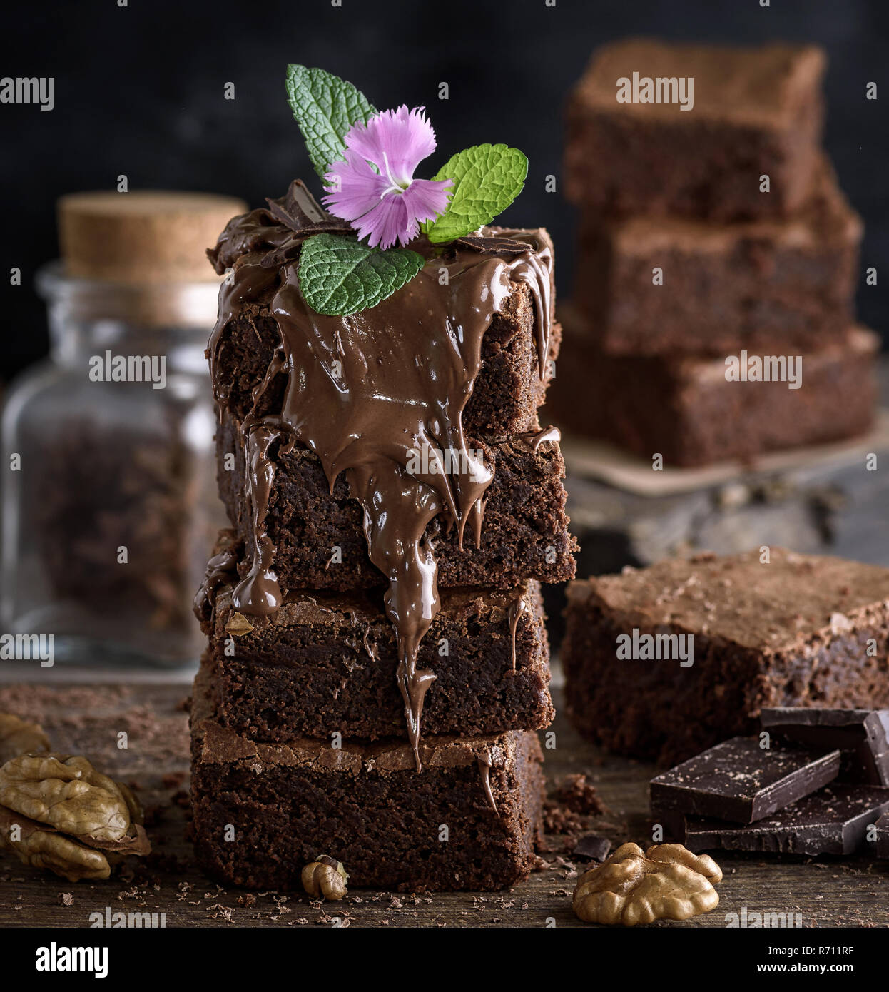 Square pieces of chocolate cake are covered with a thick layer of ...