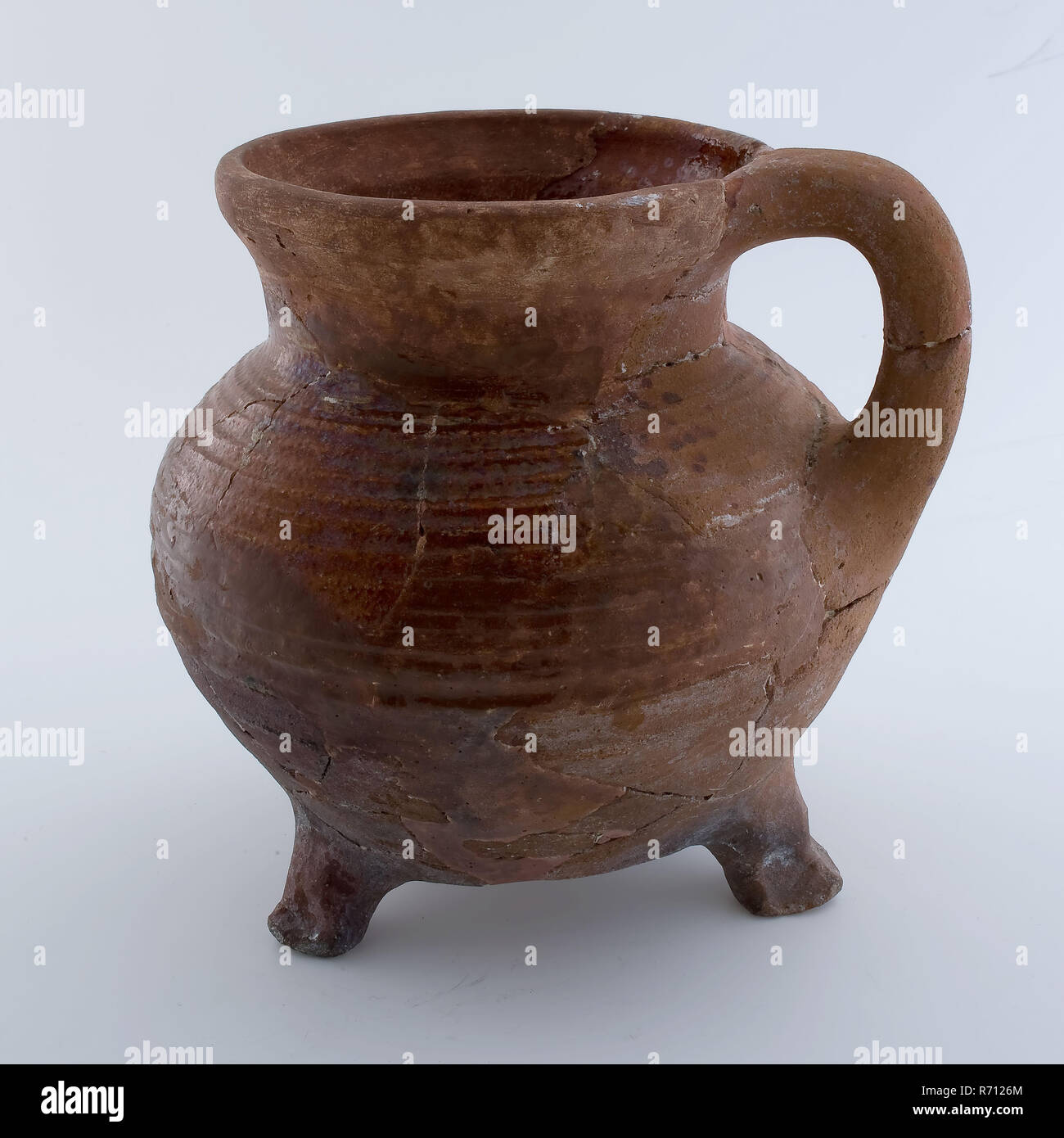 Pottery cooking jug on three legs, sausage ear, fine twisted arms on ...