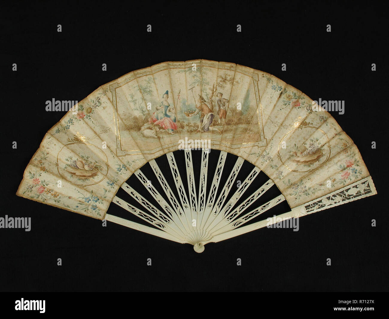 Folding fan with carved ivory frame and multicolored painted parchment ...
