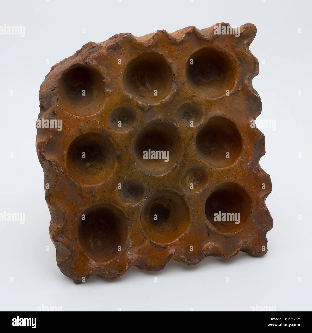 Square chicken drinking trough or chick stone, delineated by wavy rim ...