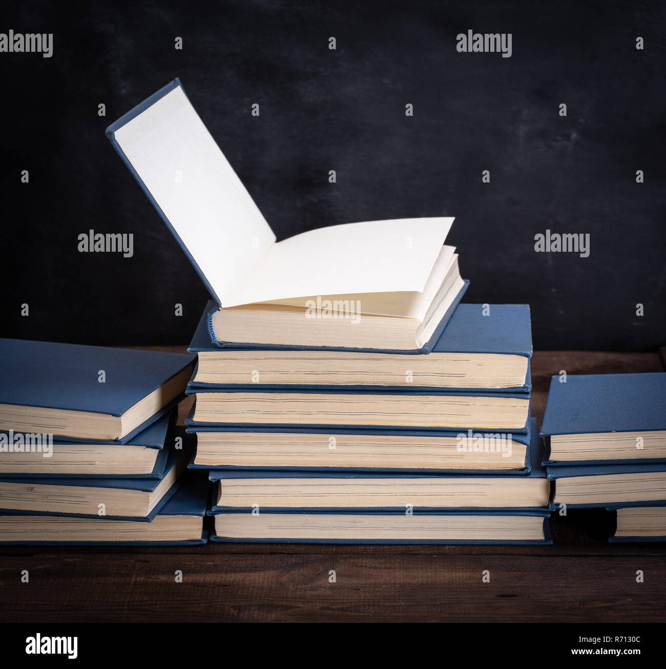 stack of various books, open book on top, close up Stock Photo - Alamy