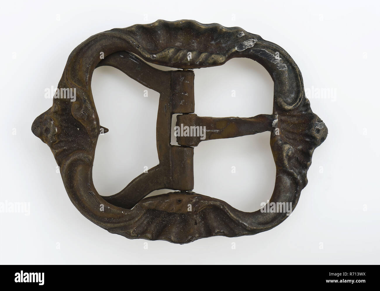 Buckle with rounded corners and curling motifs on all sides, double ...